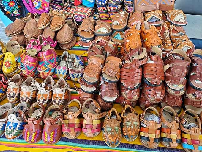 Handwoven leather sandals in warm brown tones sit beside colorful companions, promising comfort for every foot that finds them.