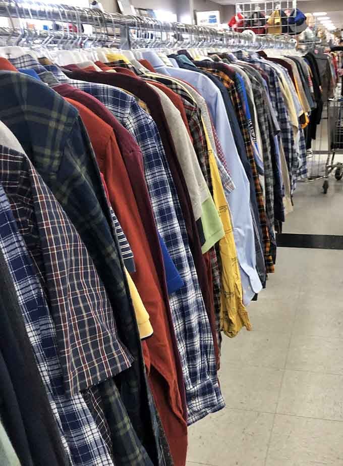 Plaid shirts hanging in perfect formation, ready to outfit lumberjacks or hipsters with equal enthusiasm.