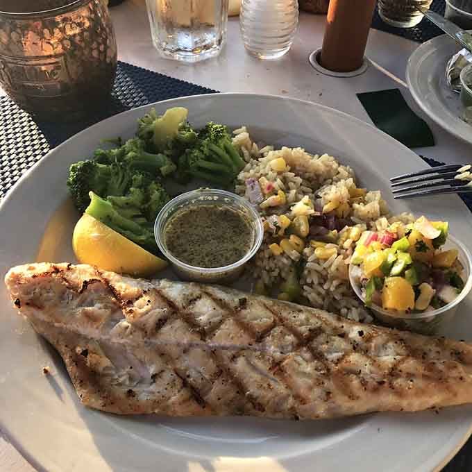 Grilled walleye with rice and vegetables proves this lakeside spot knows its way around seafood too.