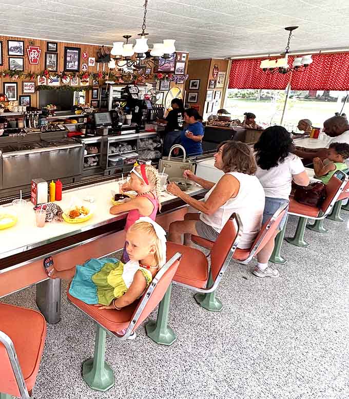 Families gather at the counter where trains run overhead, creating memories one cheeseburger delivery at a time for all ages.