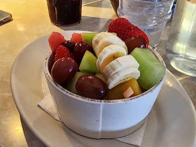 Fresh fruit bowl so colorful and inviting, it almost makes you forget about the pancakes.