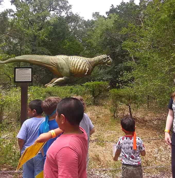 Young paleontologists gather around their discovery, proving that learning beats screen time when dinosaurs are involved here.