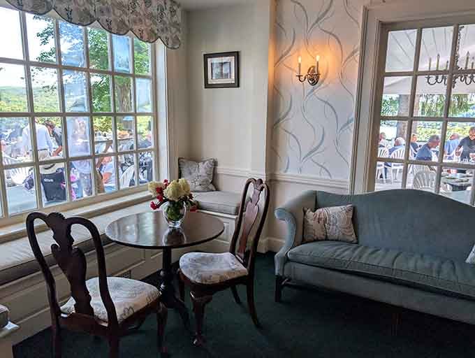 Cozy seating areas with floral wallpaper create intimate spaces where you can relax before or after your lakeside feast.