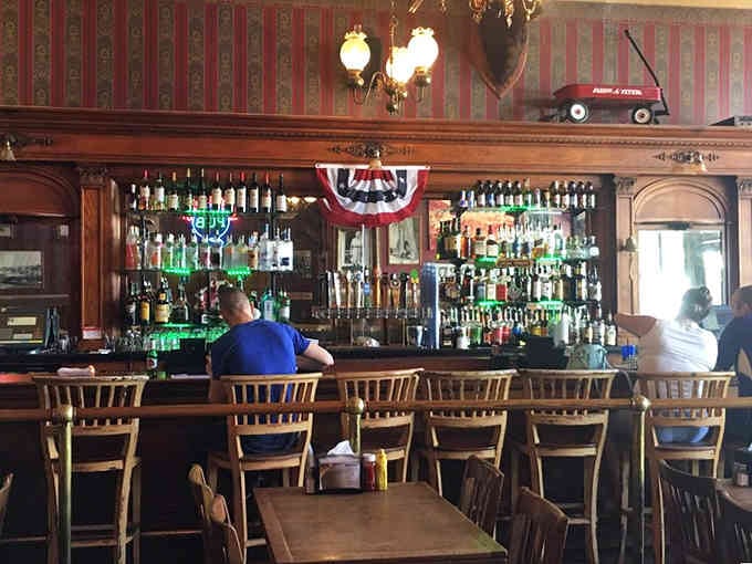 The classic wooden bar has served countless patrons over the decades, and possibly still serves a few from beyond.