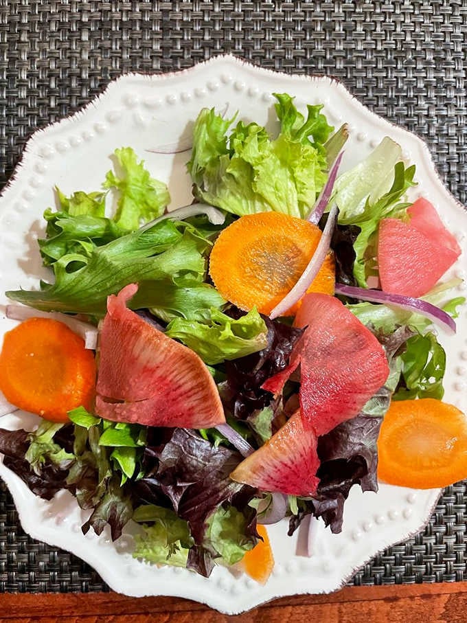 Even the salads get the gourmet treatment with colorful beets and carrots arranged like they're posing for their close-up.