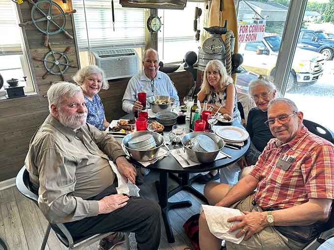 Happy diners enjoying steampots together, because some meals are too good to tackle alone without witnesses.