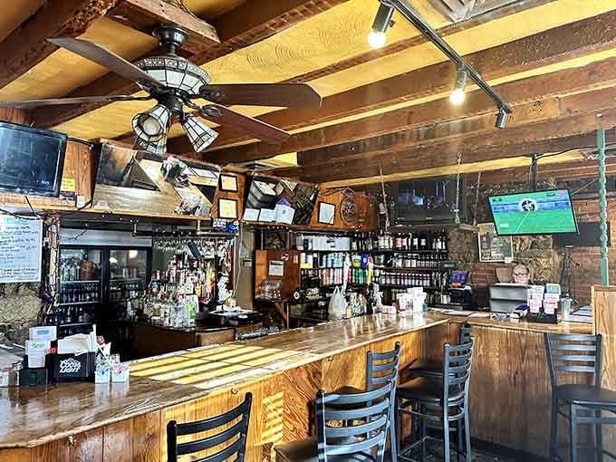 The bar area glows with warm wood tones and twinkling lights, inviting you to settle in comfortably.