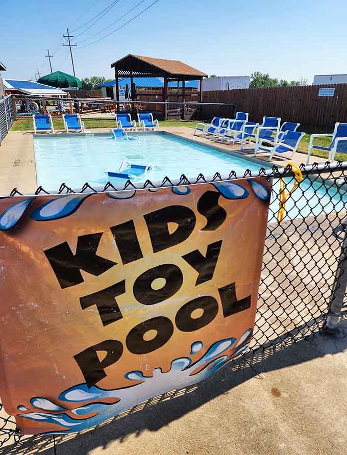 The kiddie pool provides shallow splashing zones where toddlers reign supreme, safe from teenage cannonball enthusiasts nearby.