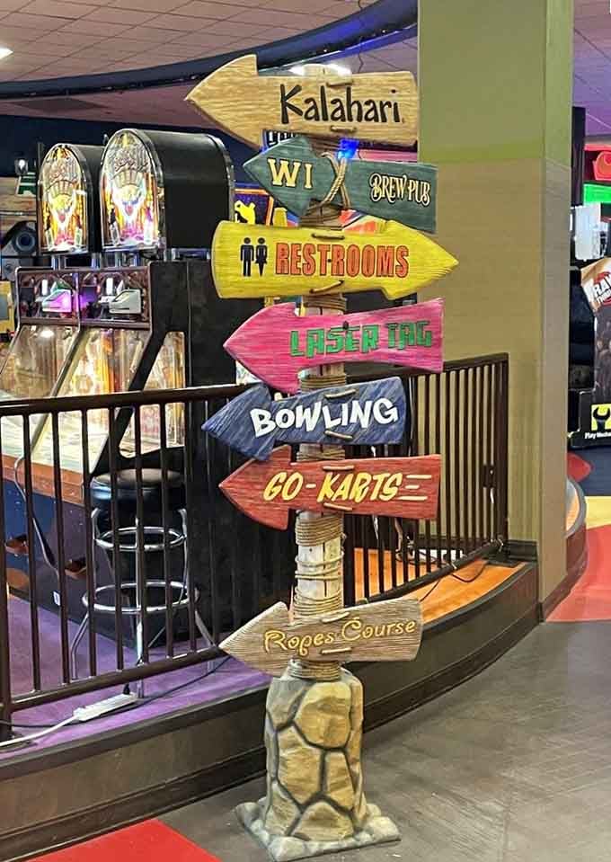 Directional signs point everywhere at once, which somehow perfectly captures the organized chaos of this indoor entertainment wonderland.