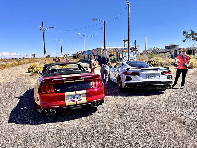 Modern muscle cars meet vintage roadside ruins, proving some photo ops are absolutely worth the detour off the interstate.