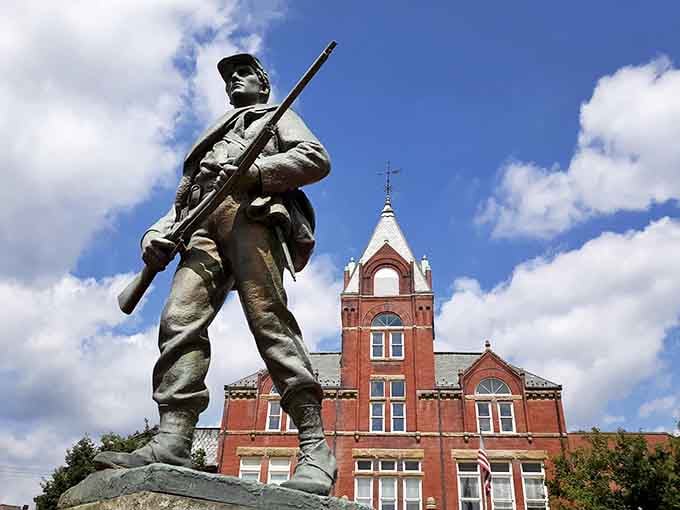 The soldier statue stands guard, a silent witness to all the drama unfolding behind those historic walls.
