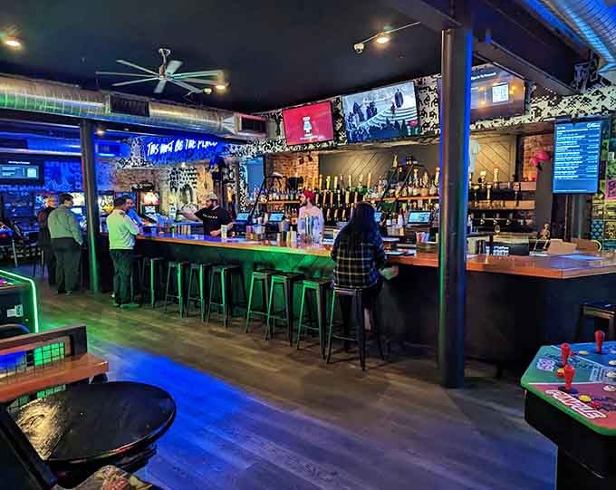 The bar glows with possibility, string lights overhead like stars guiding you toward better decisions involving craft beer and pinball.