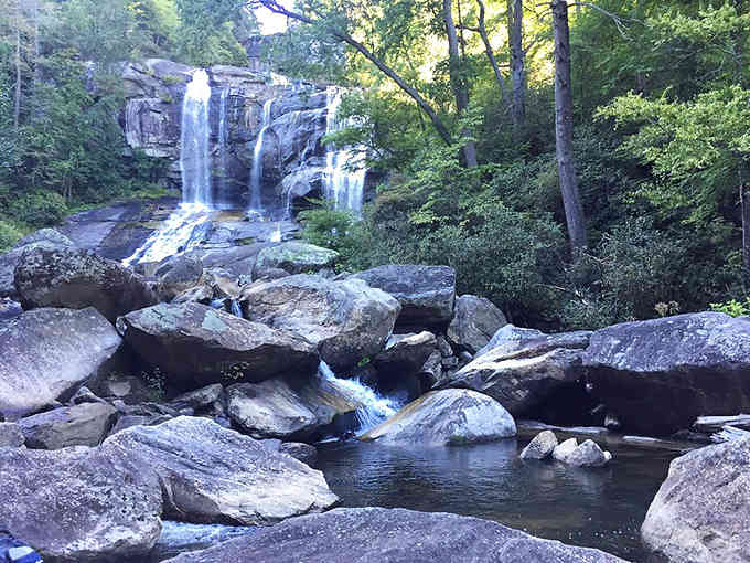 Below the main falls, the Whitewater River continues its journey over moss-covered boulders and through peaceful pools.