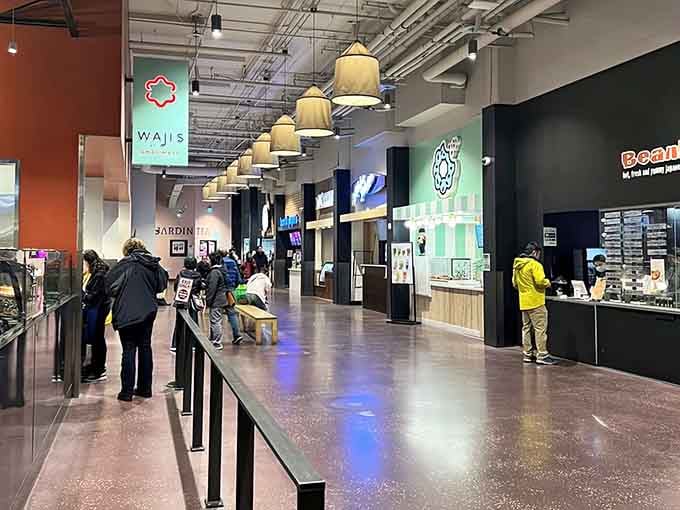 Pendant lights illuminate a dining corridor where every vendor is competing for your heart and stomach simultaneously.