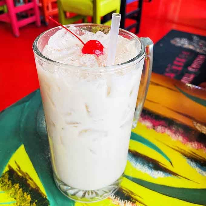 Creamy horchata topped with a cherry, because even traditional drinks deserve a little extra love and a festive finishing touch.