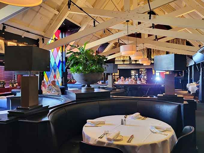 Soaring ceilings and warm lighting create a dining space that feels both grand and genuinely welcoming simultaneously.