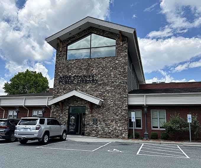 Ashe County Public Library's modern stone tower rises above the landscape, proving small towns value knowledge too.