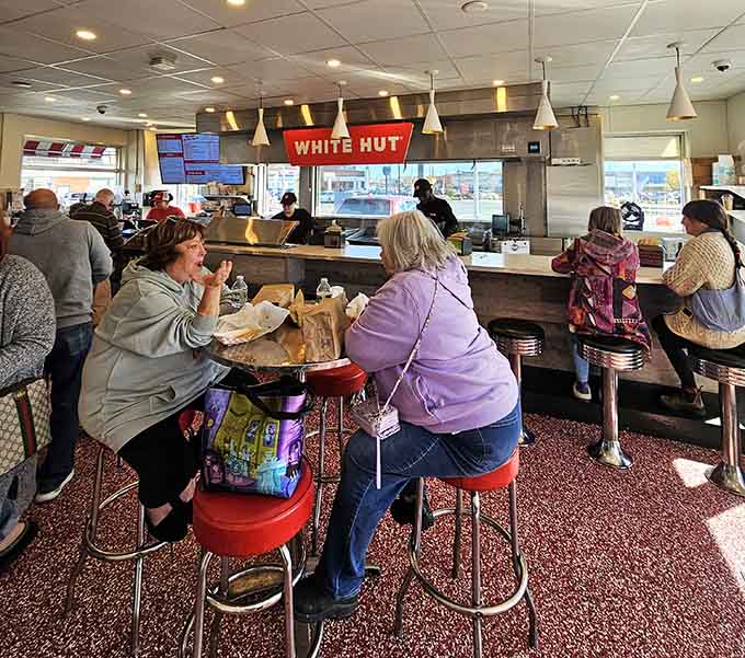 Generations gather at the counter where strangers become friends united by their excellent taste in burgers.