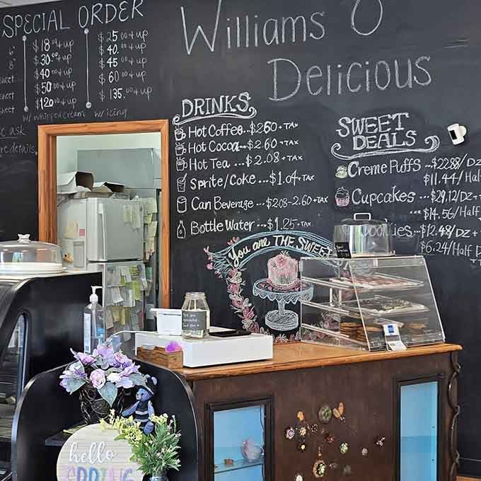 The chalkboard wall behind the register reads like a love letter written in chalk and delicious possibilities.