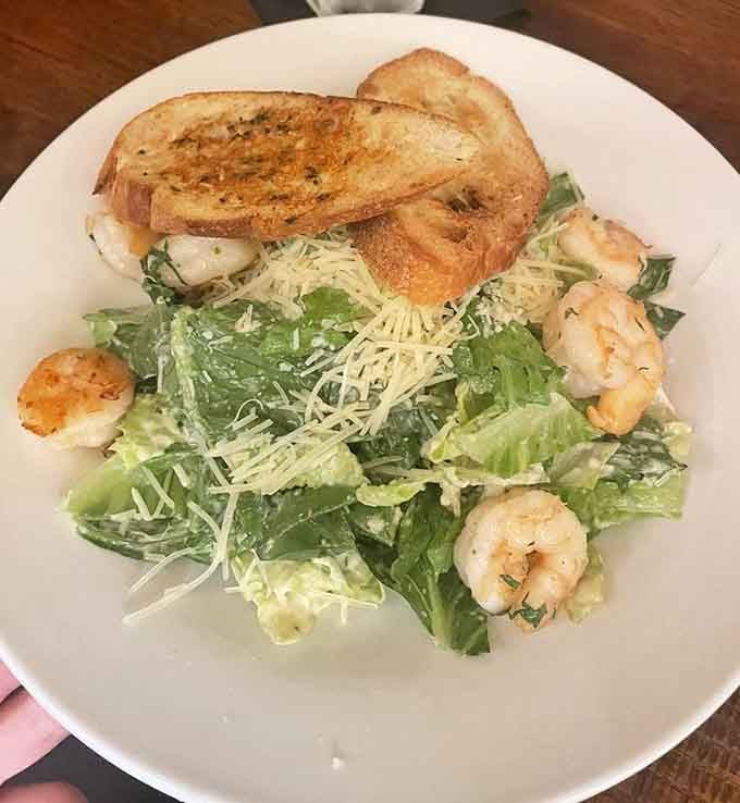 Caesar salad with shrimp and garlic bread proves that sometimes the classics just need quality execution to shine.