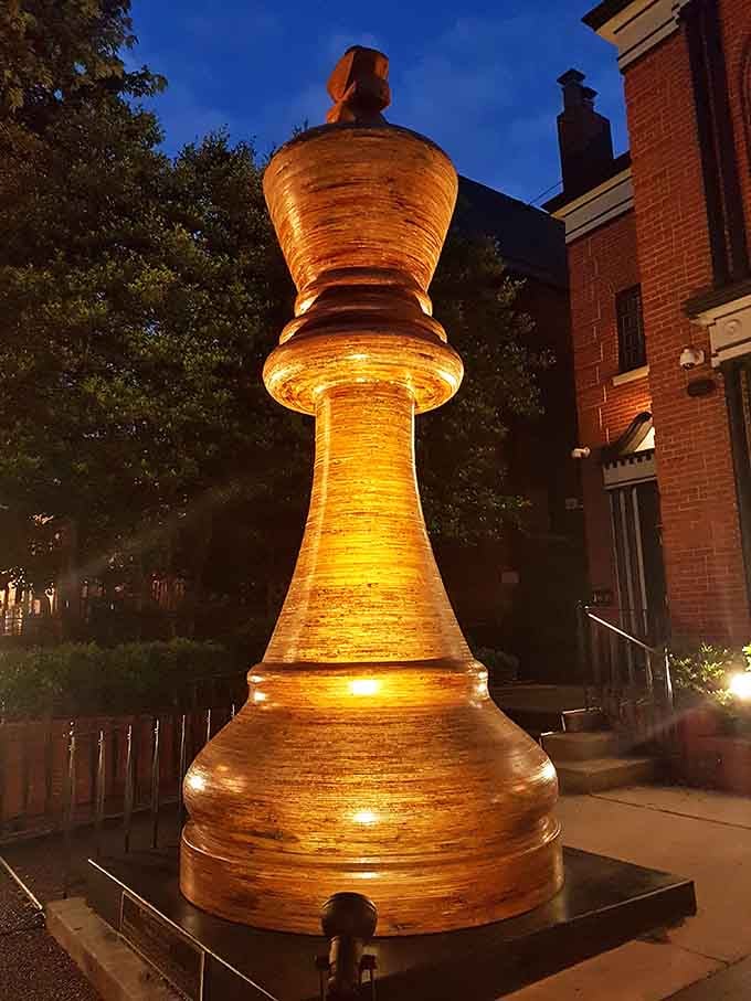 At dusk, the illuminated king glows warmly, transforming from daytime curiosity into nighttime neighborhood beacon.