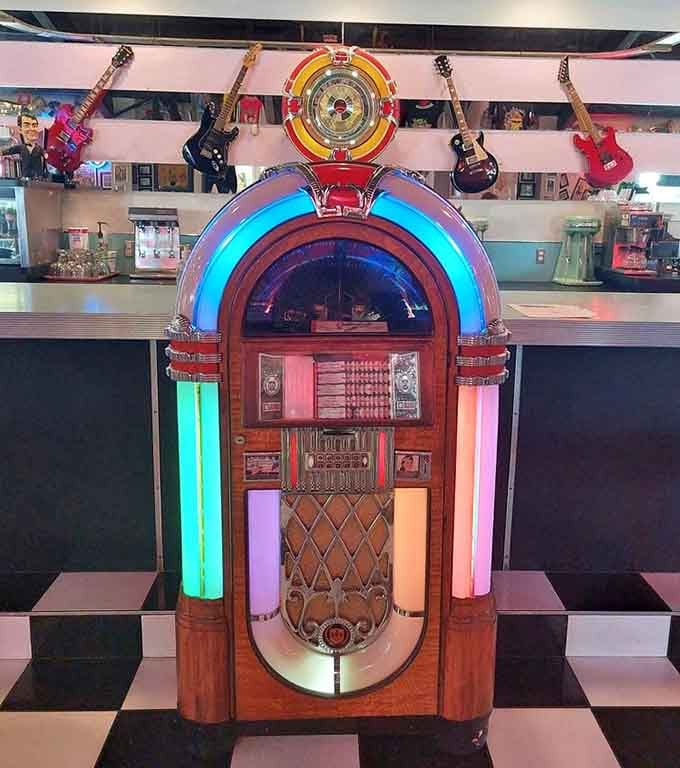 A classic jukebox standing ready to soundtrack your meal with the hits that defined an era.