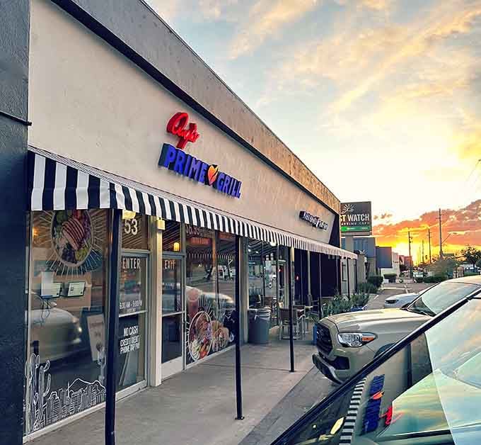 That stunning sunset paints the sky while striped awnings shelter diners enjoying prime cuts of beef.