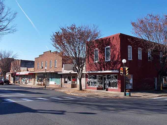 Historic brick buildings line peaceful streets where mature trees offer shaded walkways that serves as a perfect community gathering place.