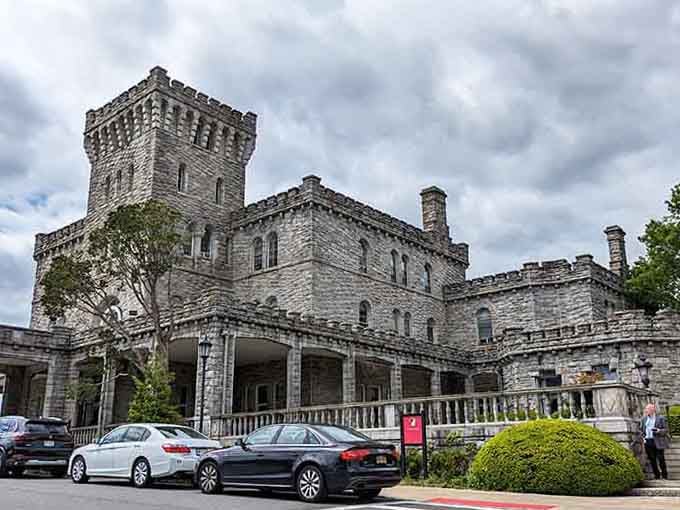 Gray stone and castellated towers stand proud against modern parking lots, bridging centuries with dignified grace and presence.