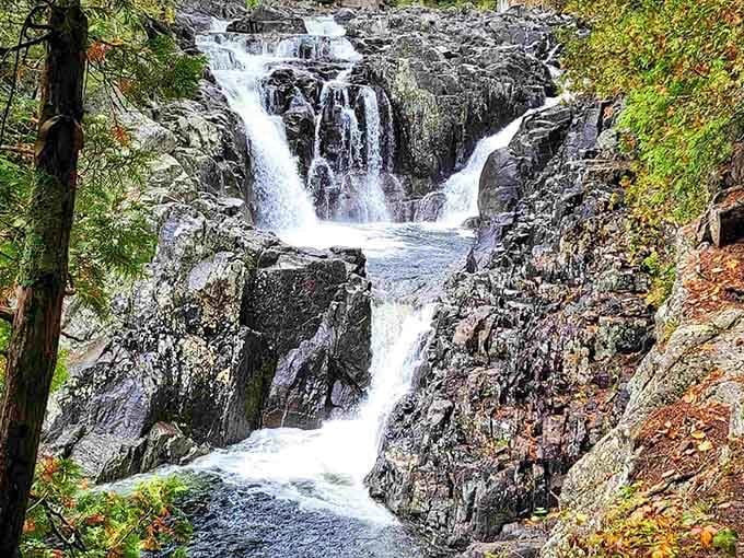 Water cascades down multiple tiers of dark rock, creating a spectacular display of nature's raw energy.