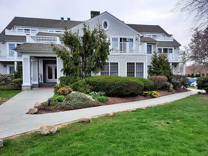Manicured grounds and elegant white architecture create an inviting entrance to this waterfront dining destination.