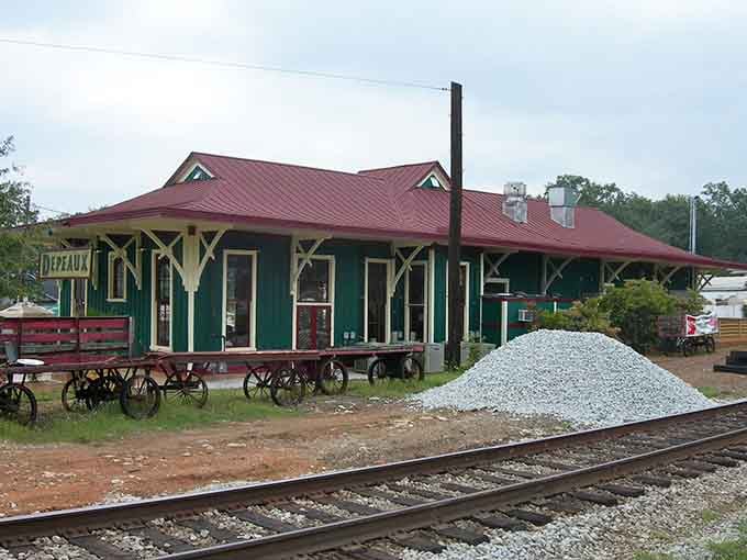 The burgundy roof and forest green walls on this depot prove that railroad architecture knew how to dress sharp.
