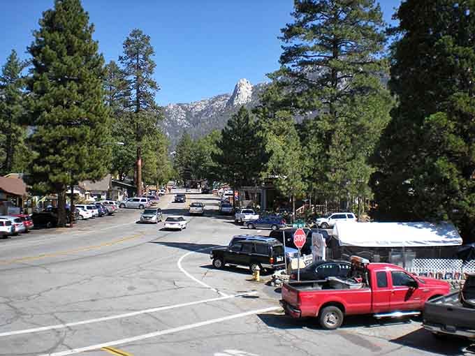 Snow lingers on the roadside while towering peaks remind you that paradise sometimes requires a sweater and good brakes.