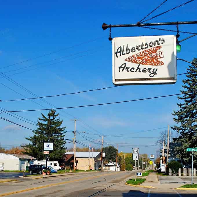 Albertson's Archery sign swinging above main street proves small towns still have room for unique businesses that big cities forgot.