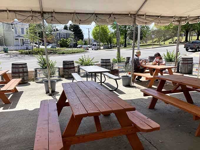 Picnic tables under a tent where strangers become friends united by their love of smoked meat.