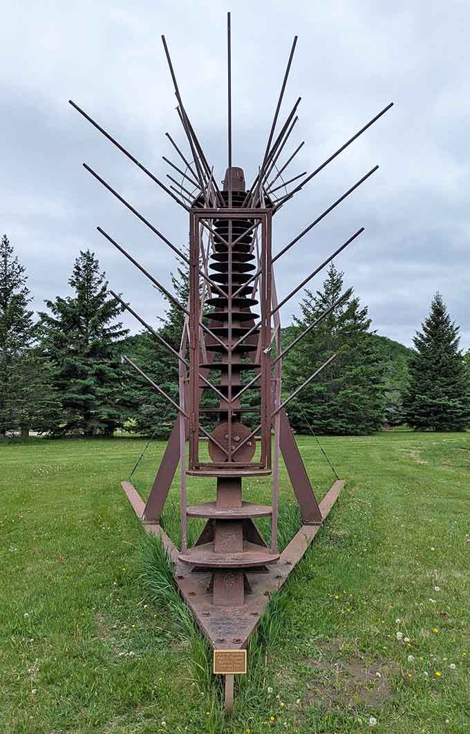 Spikes radiate from this industrial sculpture like a metal porcupine decided to become a permanent lawn ornament.