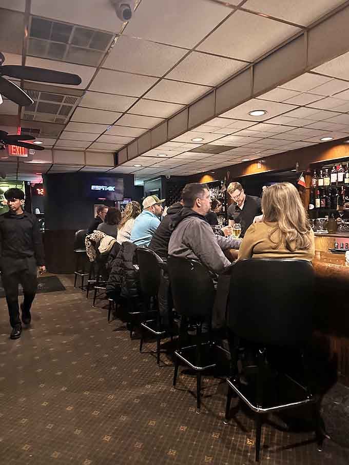 The bustling bar scene where locals gather, proving good food brings people together like nothing else can.