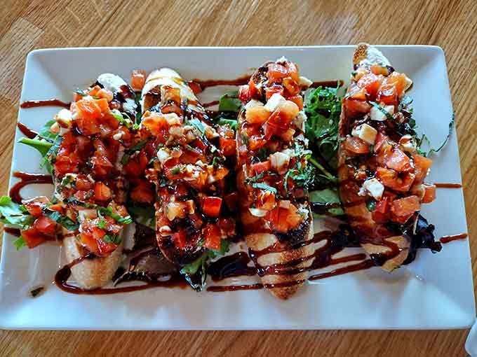 Bruschetta topped with fresh tomatoes and balsamic reduction starts your meal with bright, summery flavors that pop.