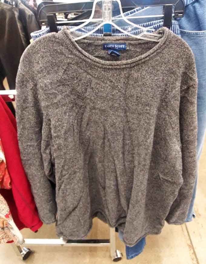 A quality sweater hanging quietly on the rack, waiting to keep someone cozy through Arizona's surprisingly chilly winter evenings.