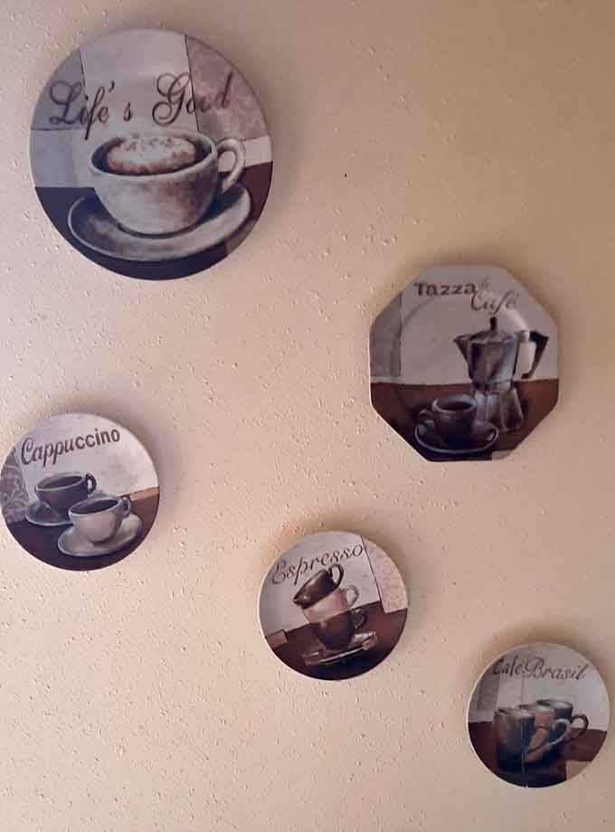 Coffee-themed wall art that speaks the universal language of caffeine lovers everywhere, bless their hearts.