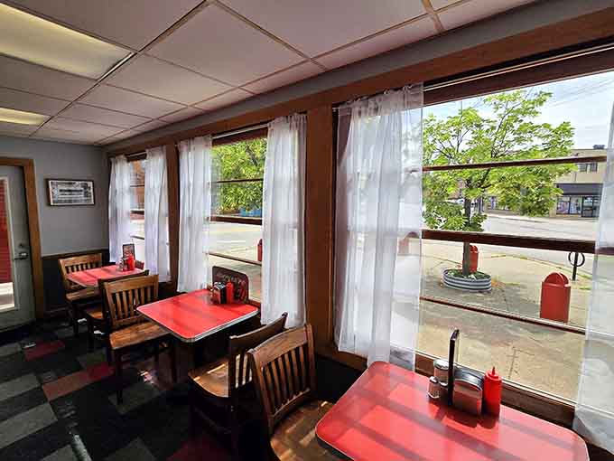 Window-side booths with red tabletops offer the perfect spot for people-watching while you eat your weight in fries.
