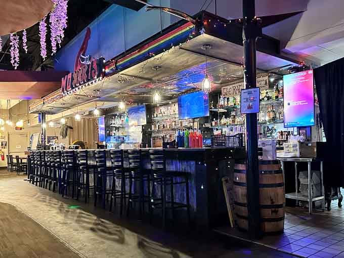The full bar stretches impressively long, stocked with craft beers and creative cocktails for every taste preference.
