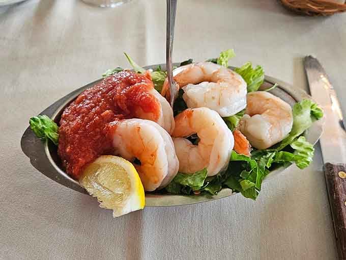 Classic shrimp cocktail on a bed of greens with lemon wedges, timeless for a reason and always welcome.