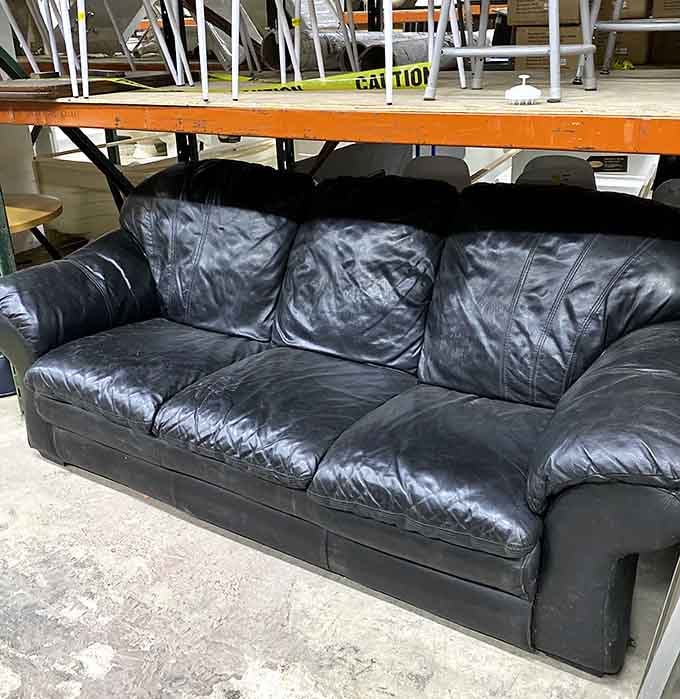 This well-loved leather sofa has stories to tell and plenty of comfortable seating left to offer.