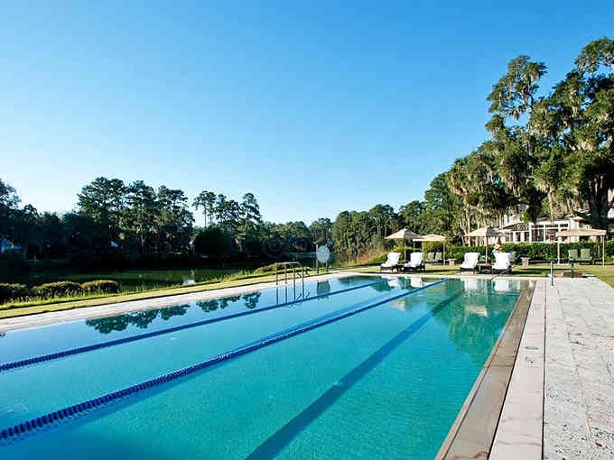 Olympic-length lanes surrounded by moss-draped oaks make morning laps feel less like exercise and more like vacation.