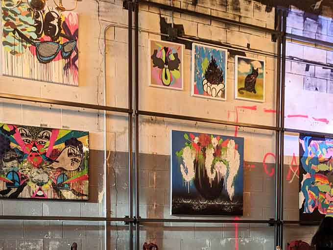 Bold street art adorning exposed brick walls transforms this dining room into an urban gallery experience.