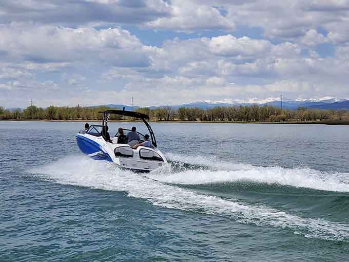 Speedboats carve through the reservoir with Rocky Mountain peaks watching from afar, creating postcard-worthy action shots.