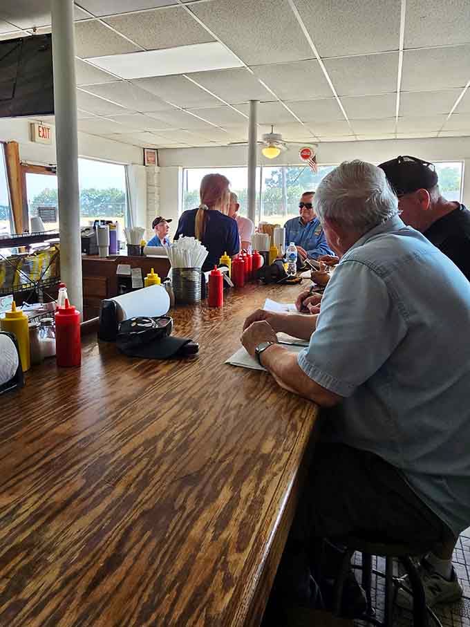 Behind the counter, staff work with the efficiency of people who've made thousands of perfect dogs.
