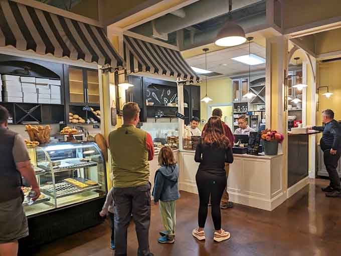 Families gathering at the counter, deciding between too many delicious options, is the universal language of good bakeries everywhere.
