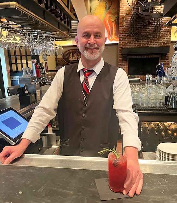 The friendly bartender crafting cocktails with genuine care reminds you that hospitality matters as much as the food.